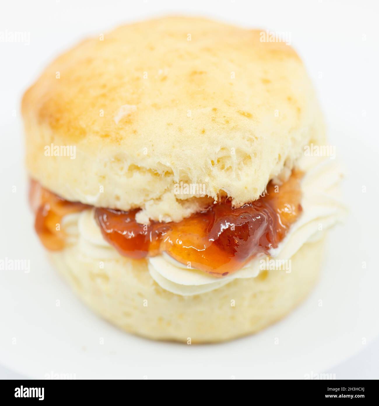Closeup of a fresh baked scone with fresh cream and raspberry jam Stock ...