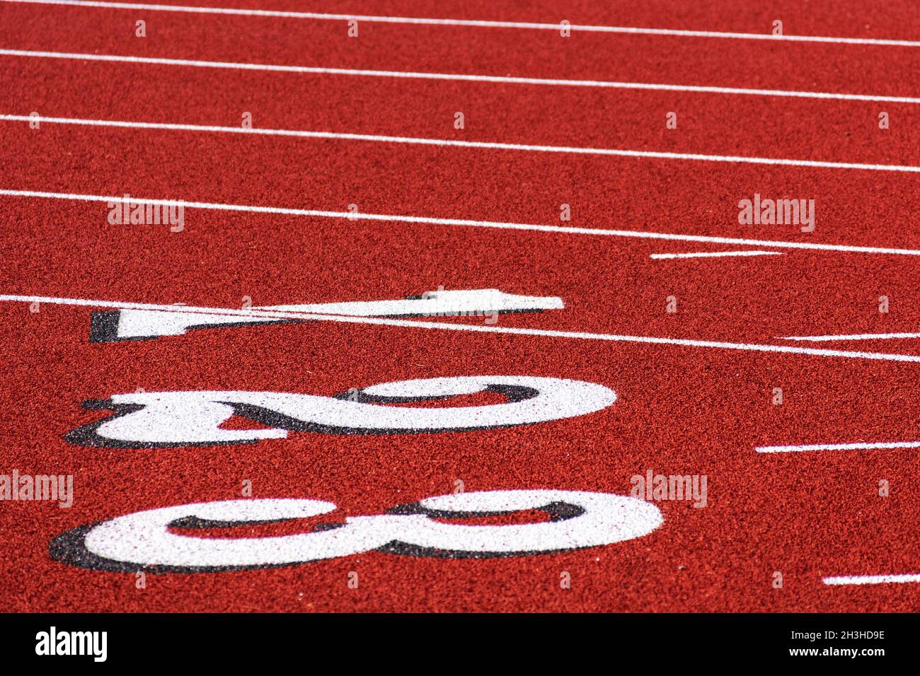 Side view of track and field race course starting line with numbers 1 ...