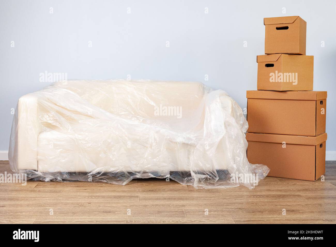 Packed household stuff in boxes and packed sofa for moving Stock Photo ...