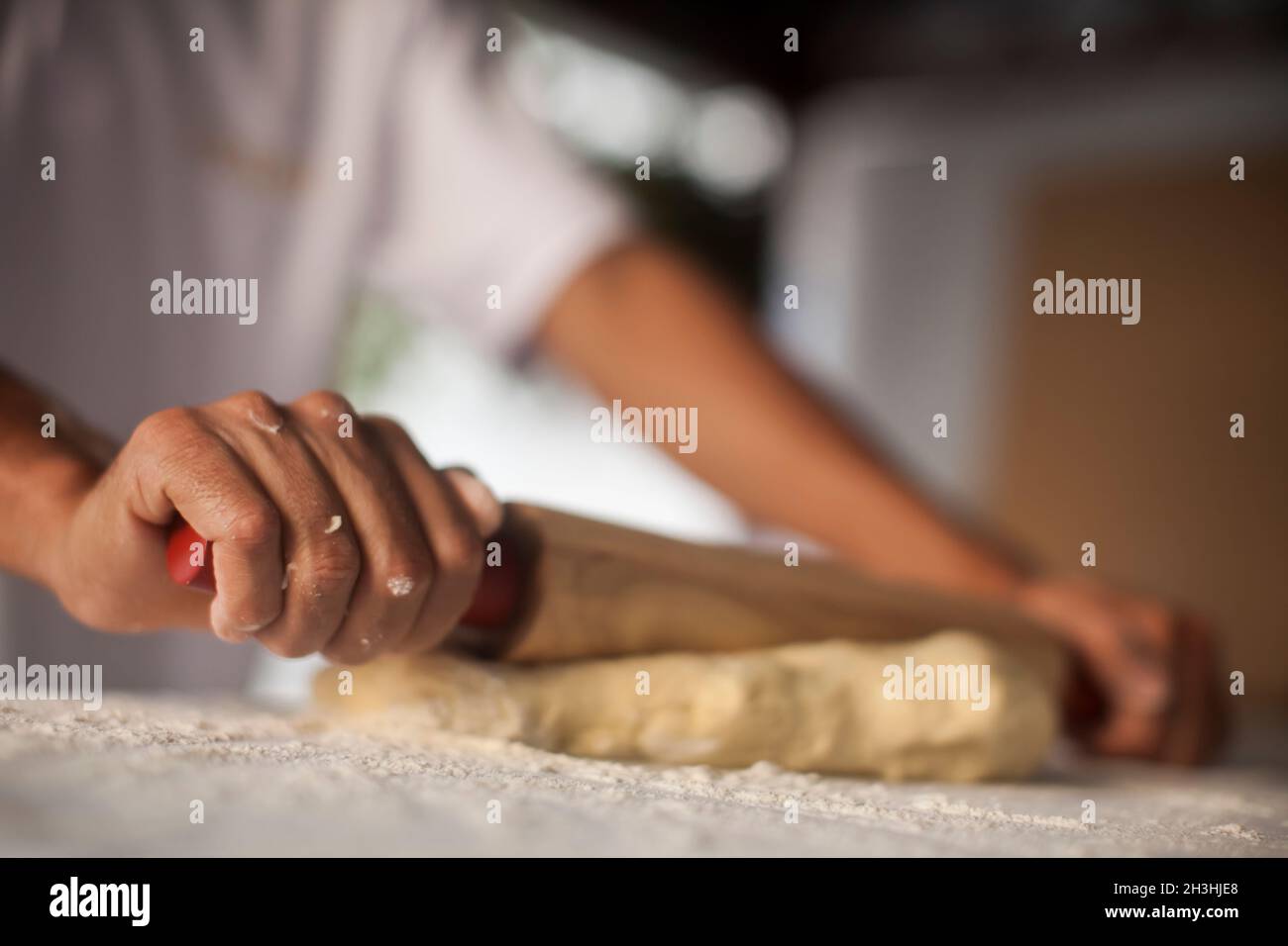 Human Hand using dough rolling pin to make pasta - making Raw and dry ...