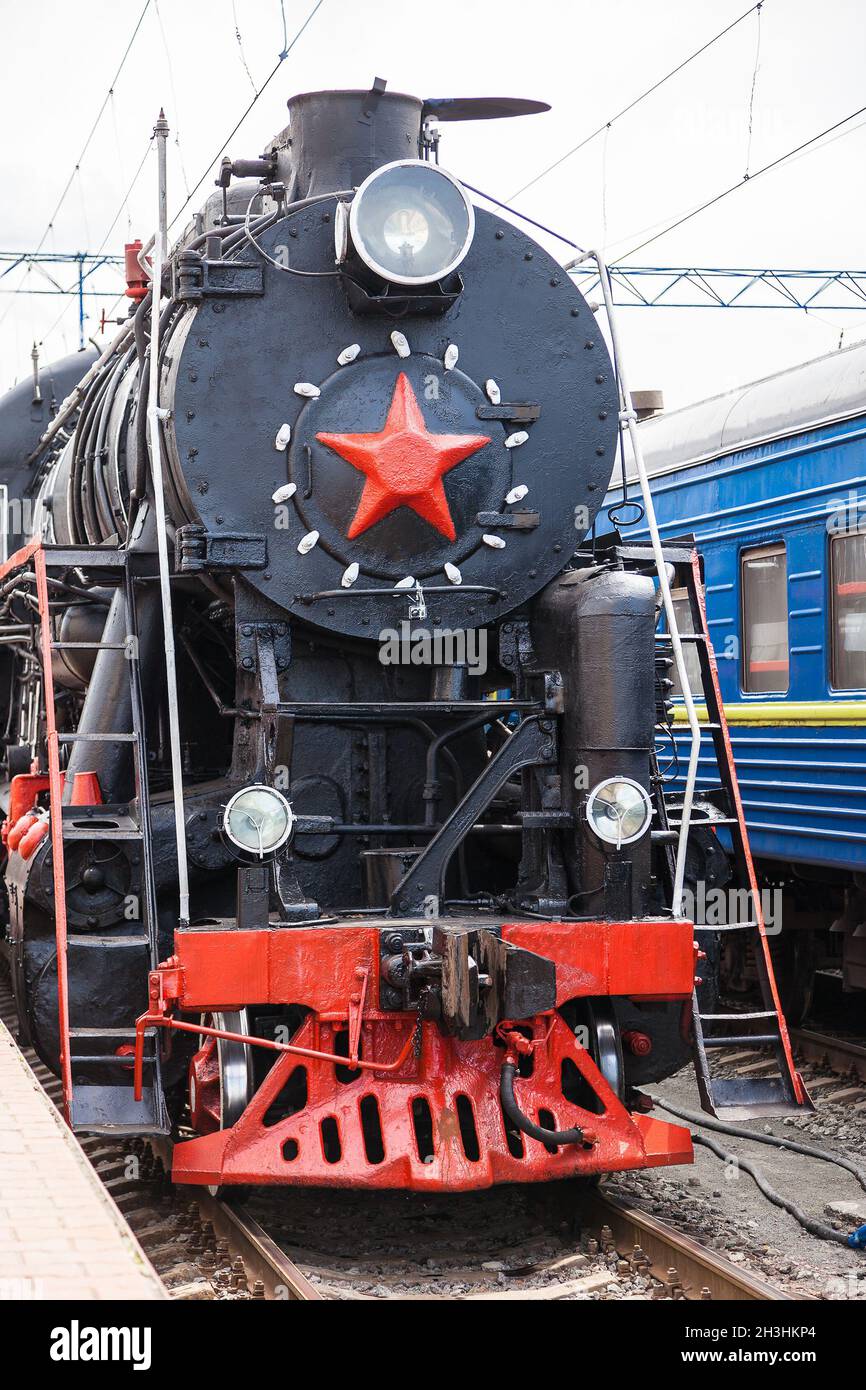 Old steam train is leaving a station Stock Photo - Alamy