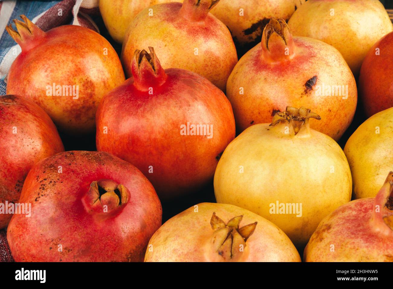 Group of pomegranate fruits close up background Stock Photo - Alamy