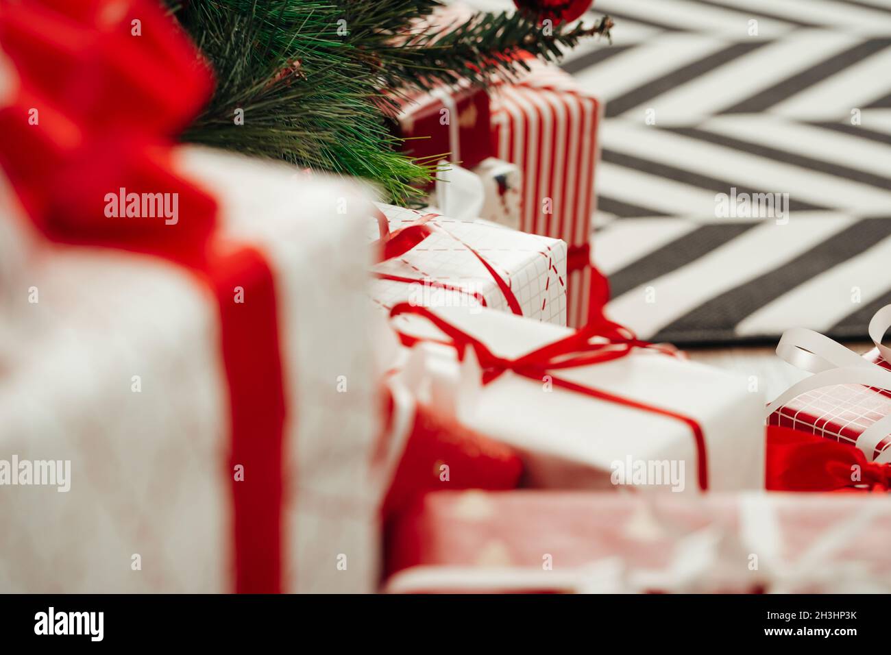 Pile of wrapped presents under the Christmas tree Stock Photo - Alamy