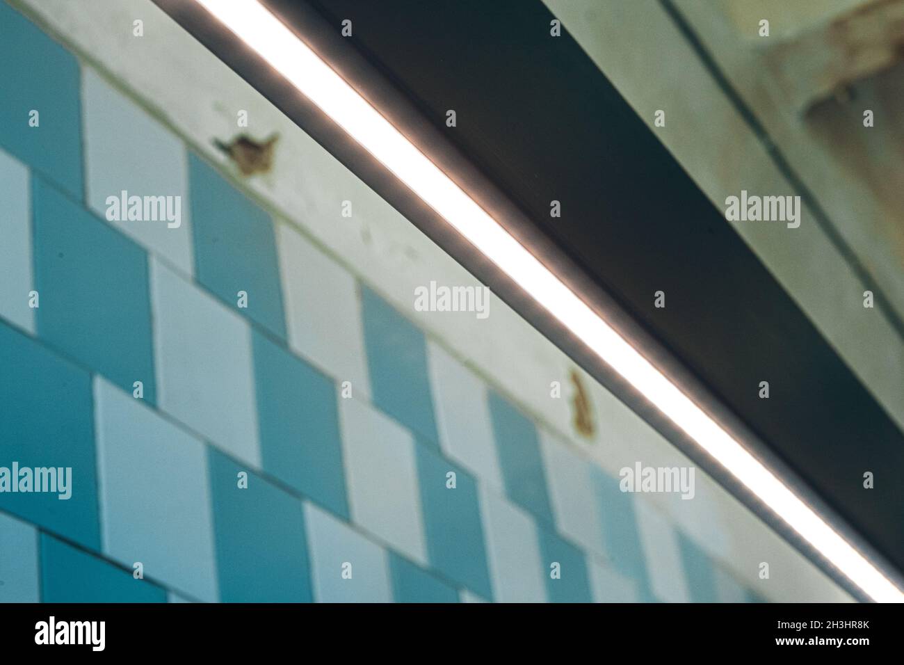 Old tiled wall used in a modern loft interior Stock Photo - Alamy