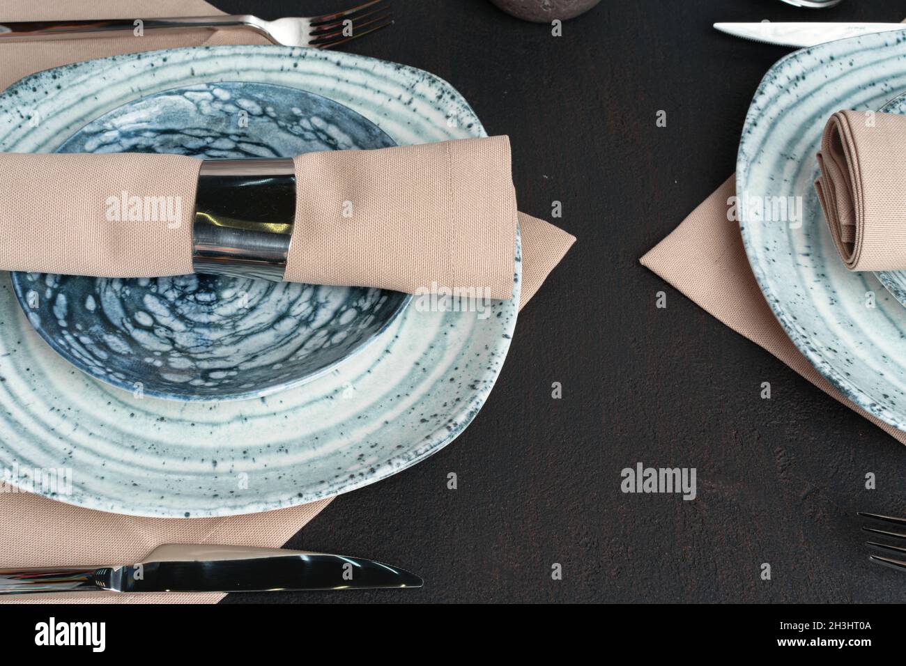 Table setting. Plates with abstract pattern on black table Stock Photo ...