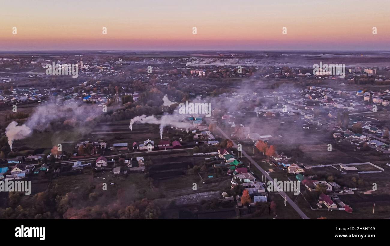 top view over the old village with burning bonfires and smoke flying ...