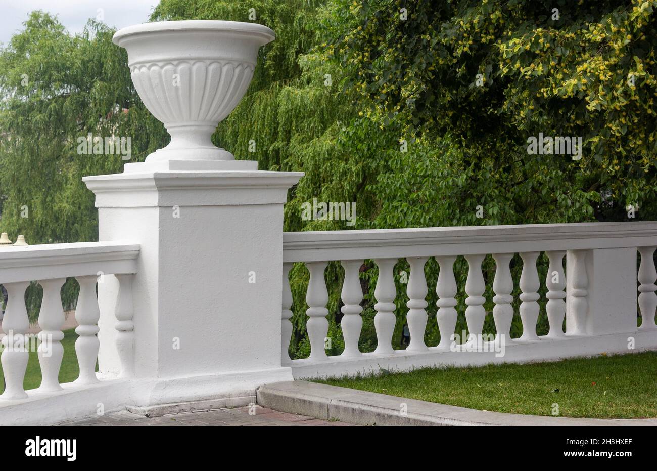 Old classic white balustrade with antique vase in the park of Minsk ...