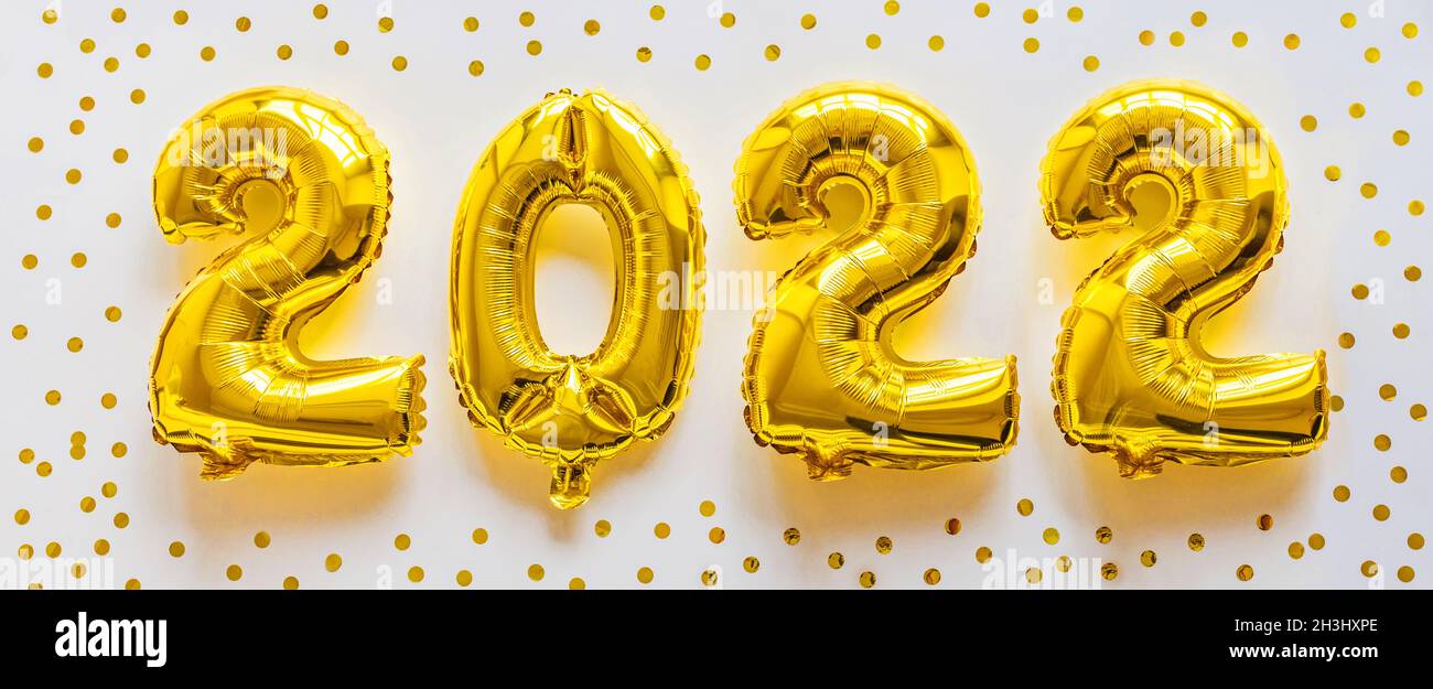 Foil balloons golden color in the form of numbers 2022. New year ...