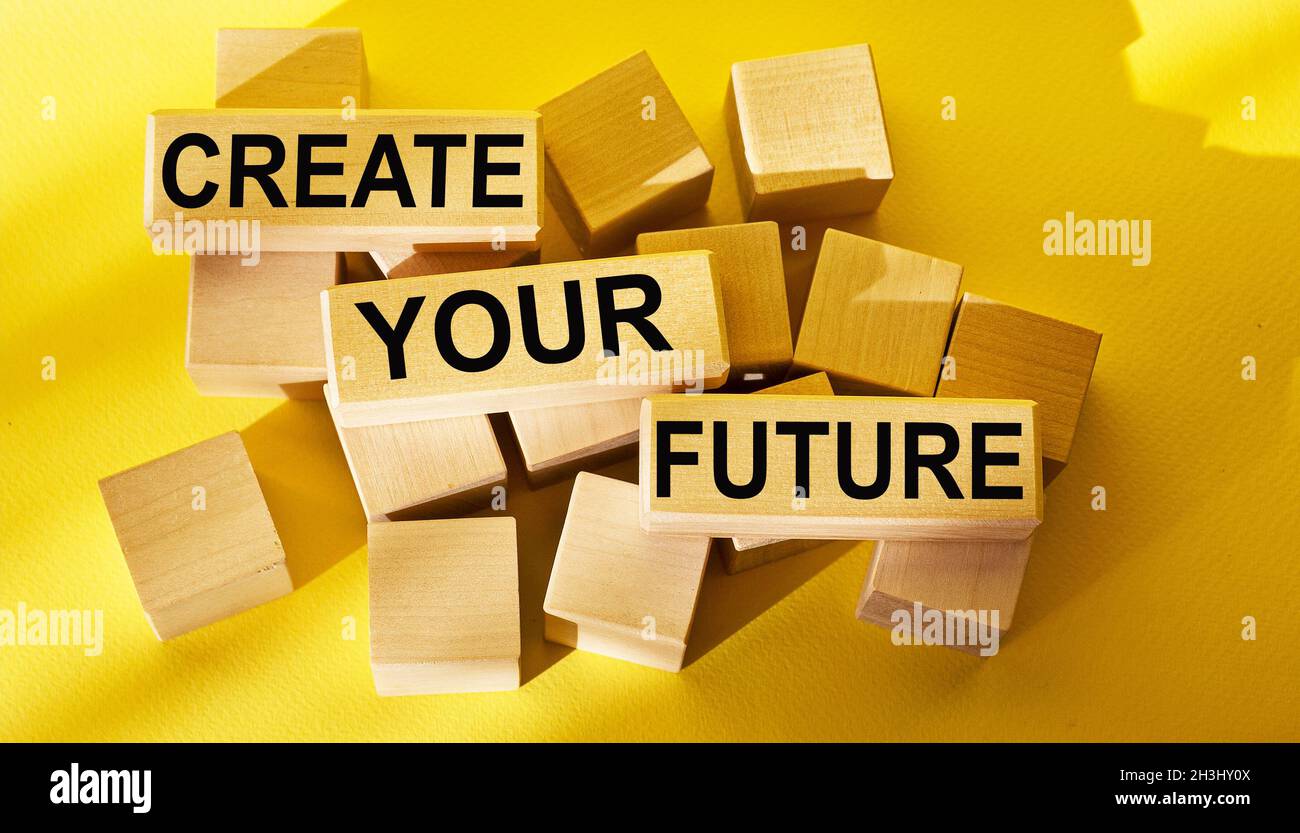 Create your future - lettering on wooden blocks on yellow background ...