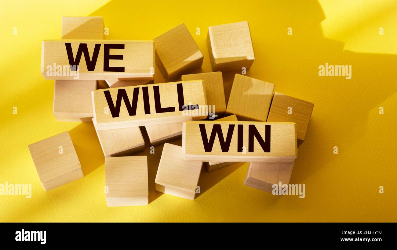 We Wii Win phrase written on wooden blocks and yellow background Stock ...