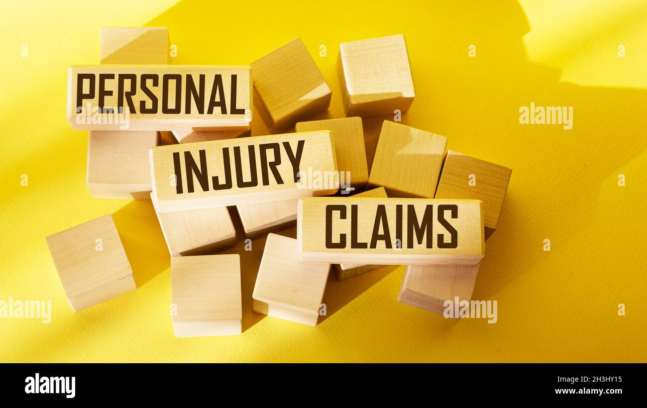 text Personal injury claims written on a wooden block , concept Stock ...