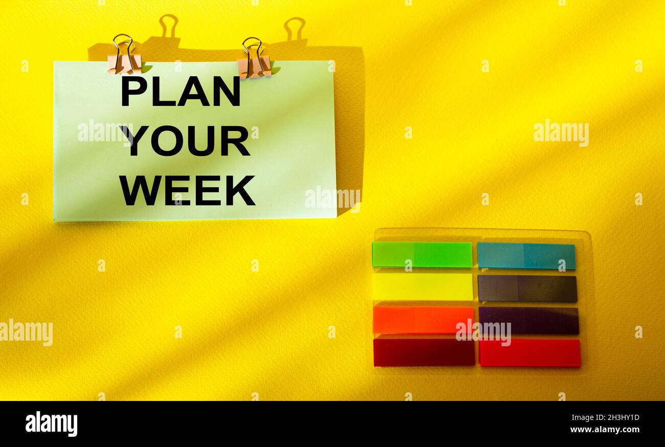 Plan your week, text is written on a sticker and on a yellow background ...