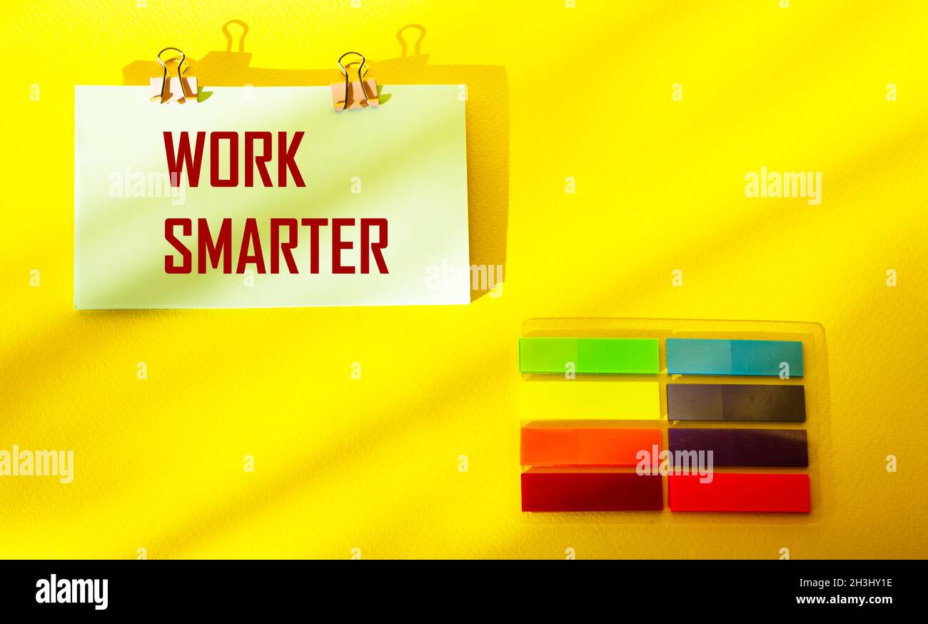 Work smarter on sticky paper on yellow background with colored stickers ...