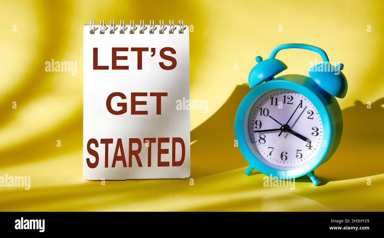 The text Let's Started is written on a calendar and a yellow background ...