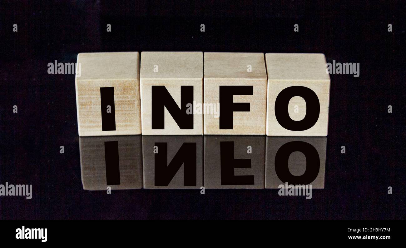 Information word written on wooden block and black glass background ...