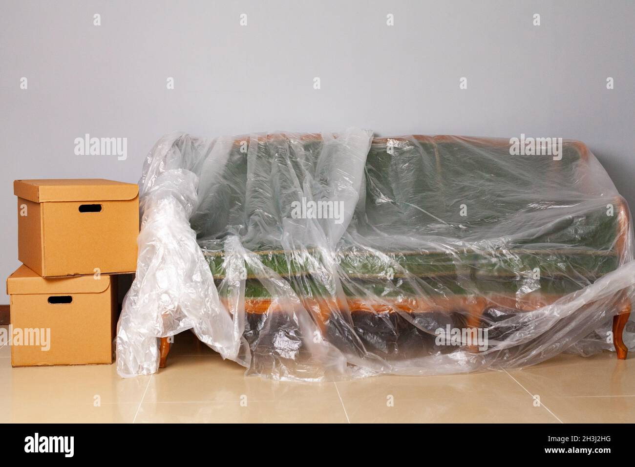 Packed household stuff in boxes and packed sofa for moving Stock Photo ...