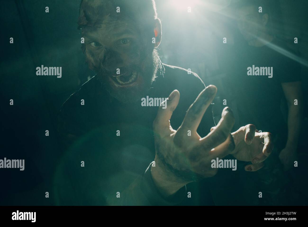 Zombie male attacking. Halloween concept. Make up skin and blood face ...