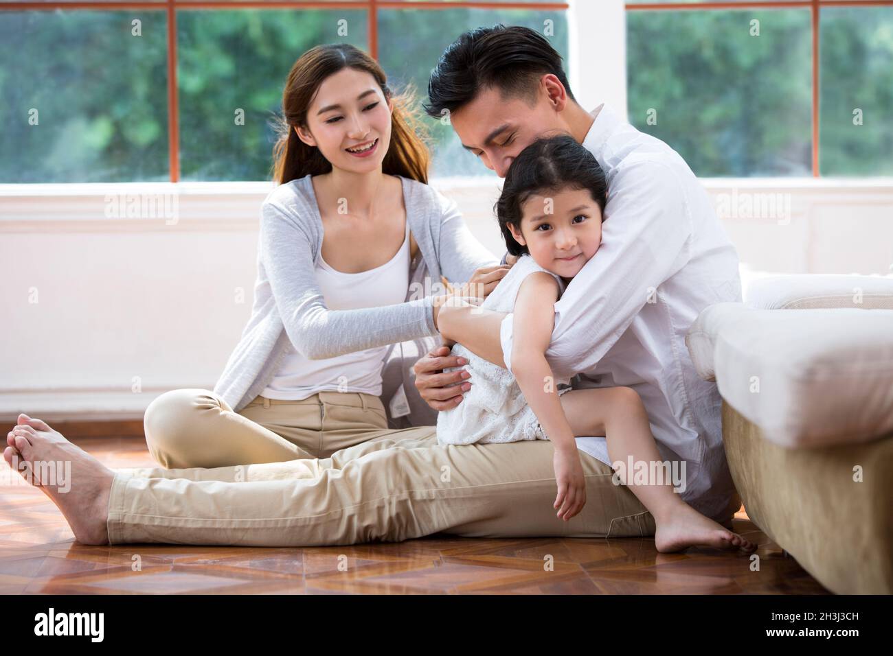 Warm and loving family of three Stock Photo - Alamy
