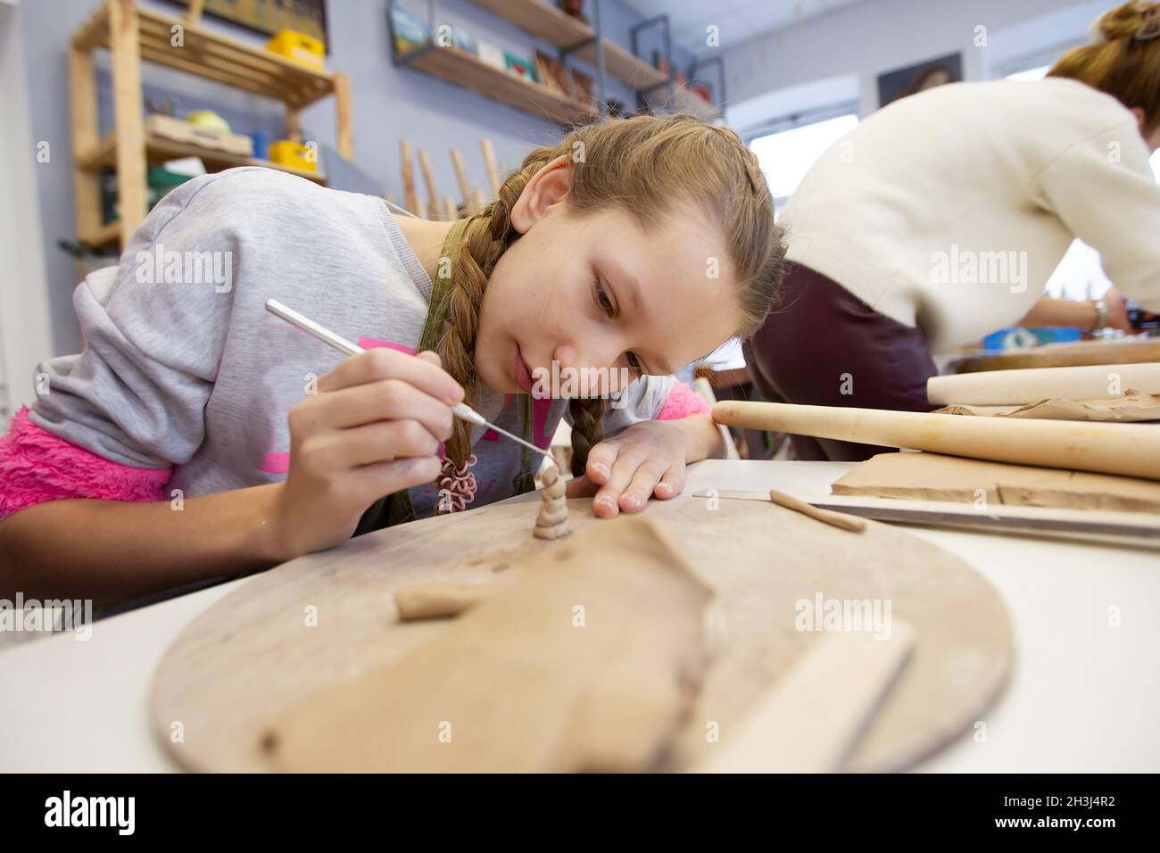Master class in clay modeling. A teenage girl sculpts from clay Stock ...