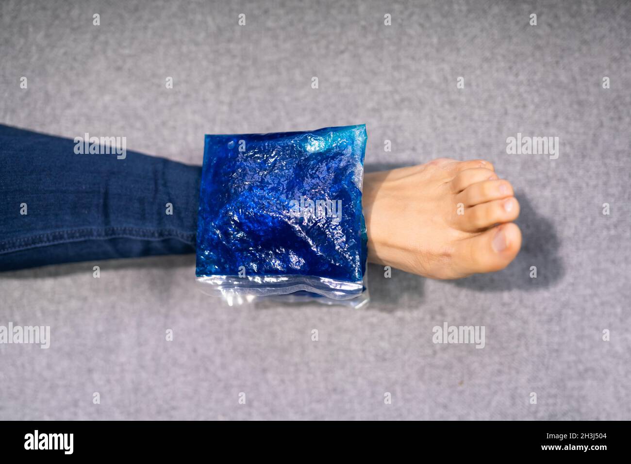 Woman Holding Icing Gel Therapy Pack After Leg Injury Stock Photo - Alamy