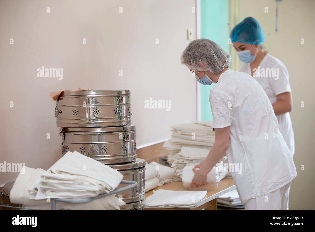 The nurses in the hospital are folding the bedding. Hospital attendants ...