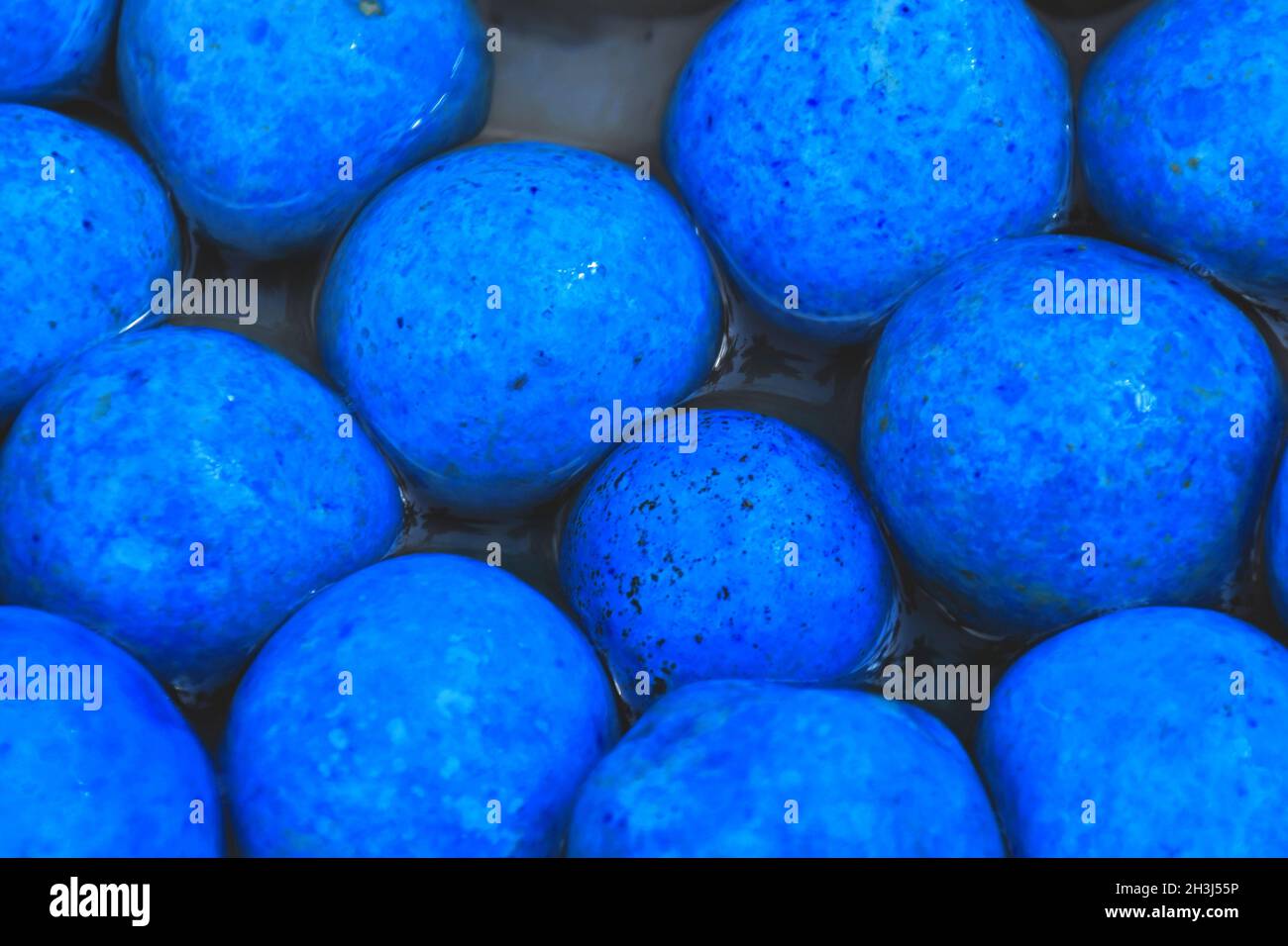 Closeup of blue balls in the water Stock Photo - Alamy