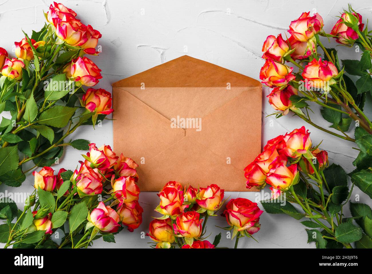 Craft paper envelope with bunch of flowers Stock Photo - Alamy