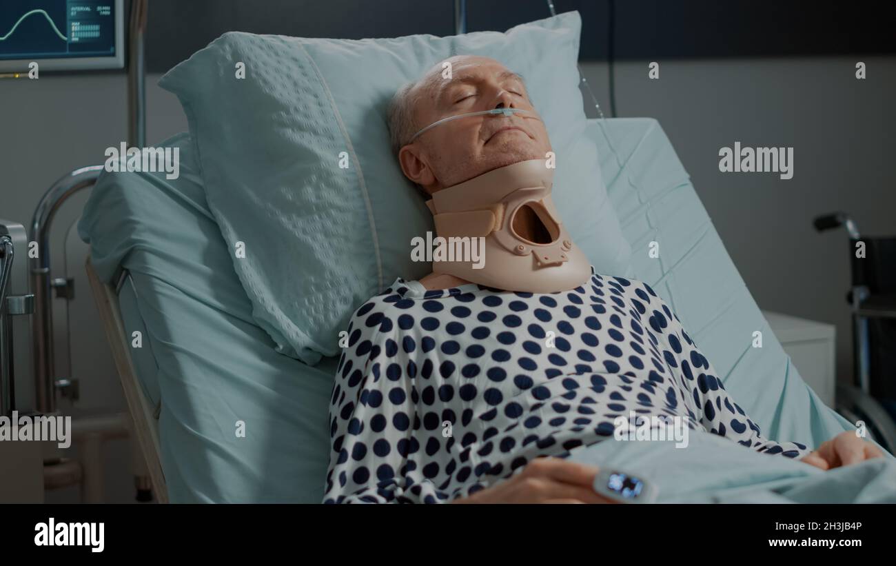 Portrait of elder patient sitting with cervical neck collar in hospital ...