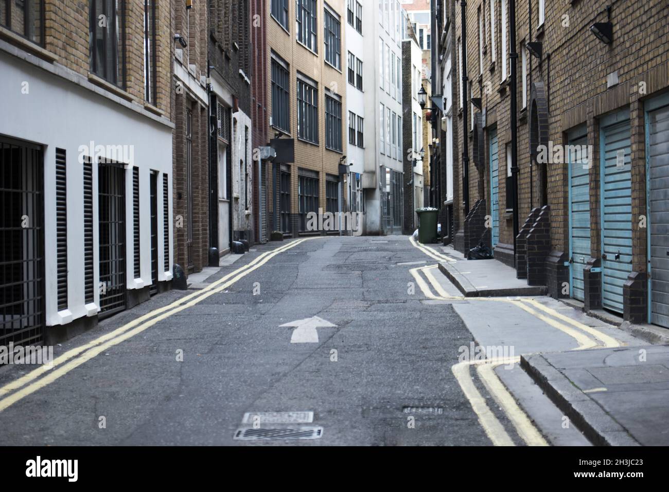 One way narrow urban street Stock Photo - Alamy