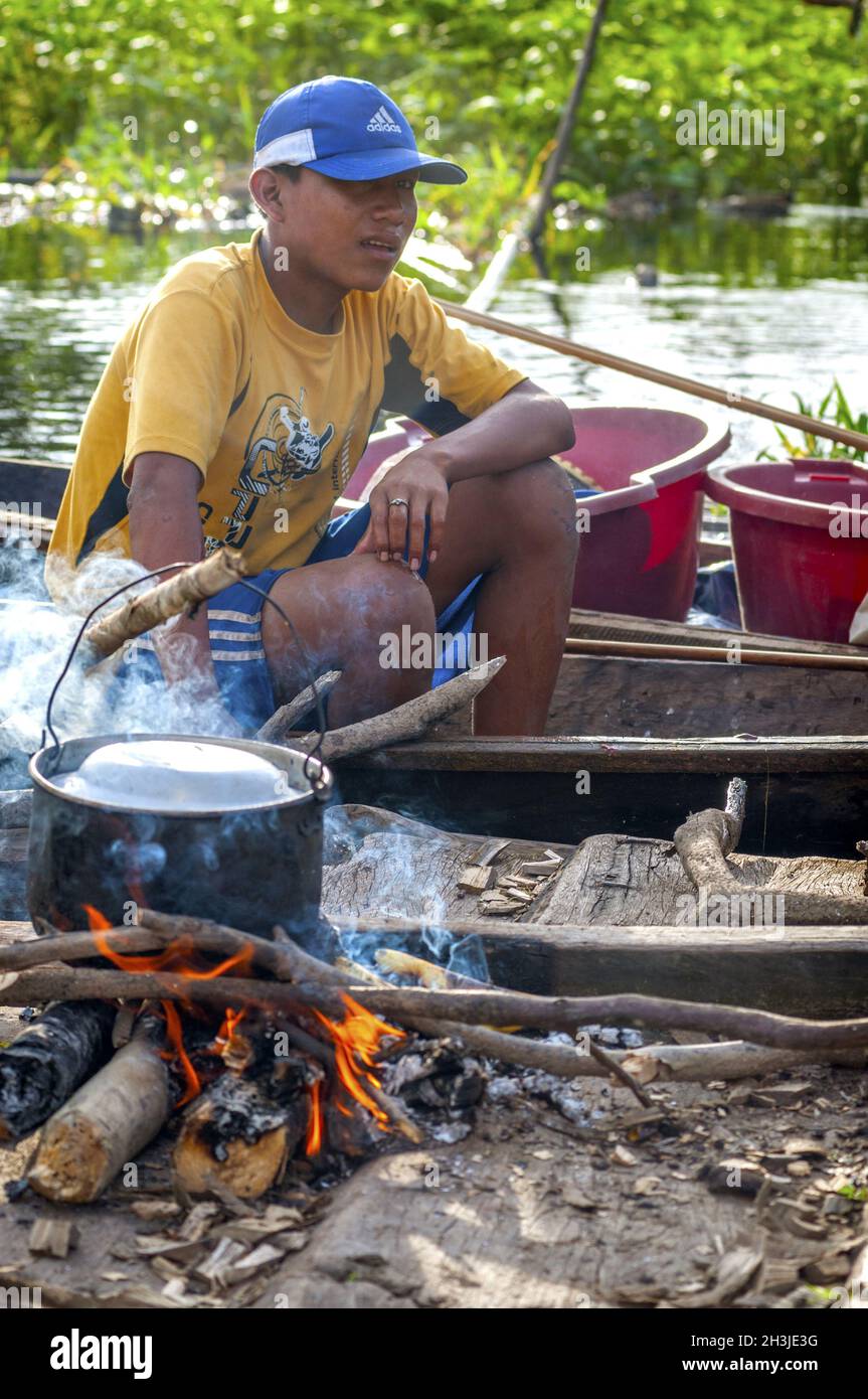 AMAZONIA, PERU - DEC 28: Unidentified Amazonian indigenous man cooking ...