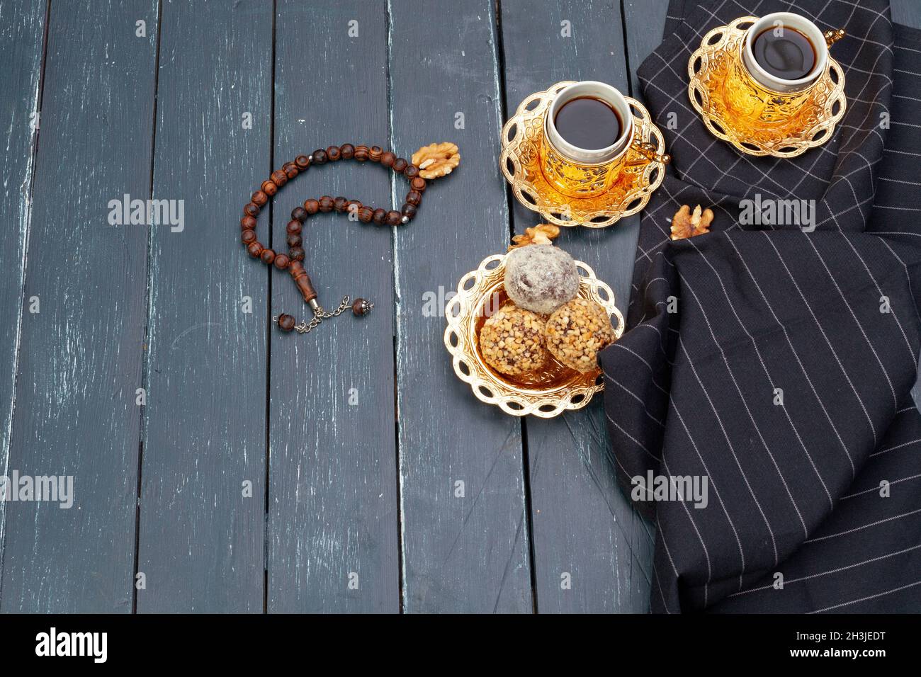 Nut balls dessert served with coffee on dark wooden table, top view ...