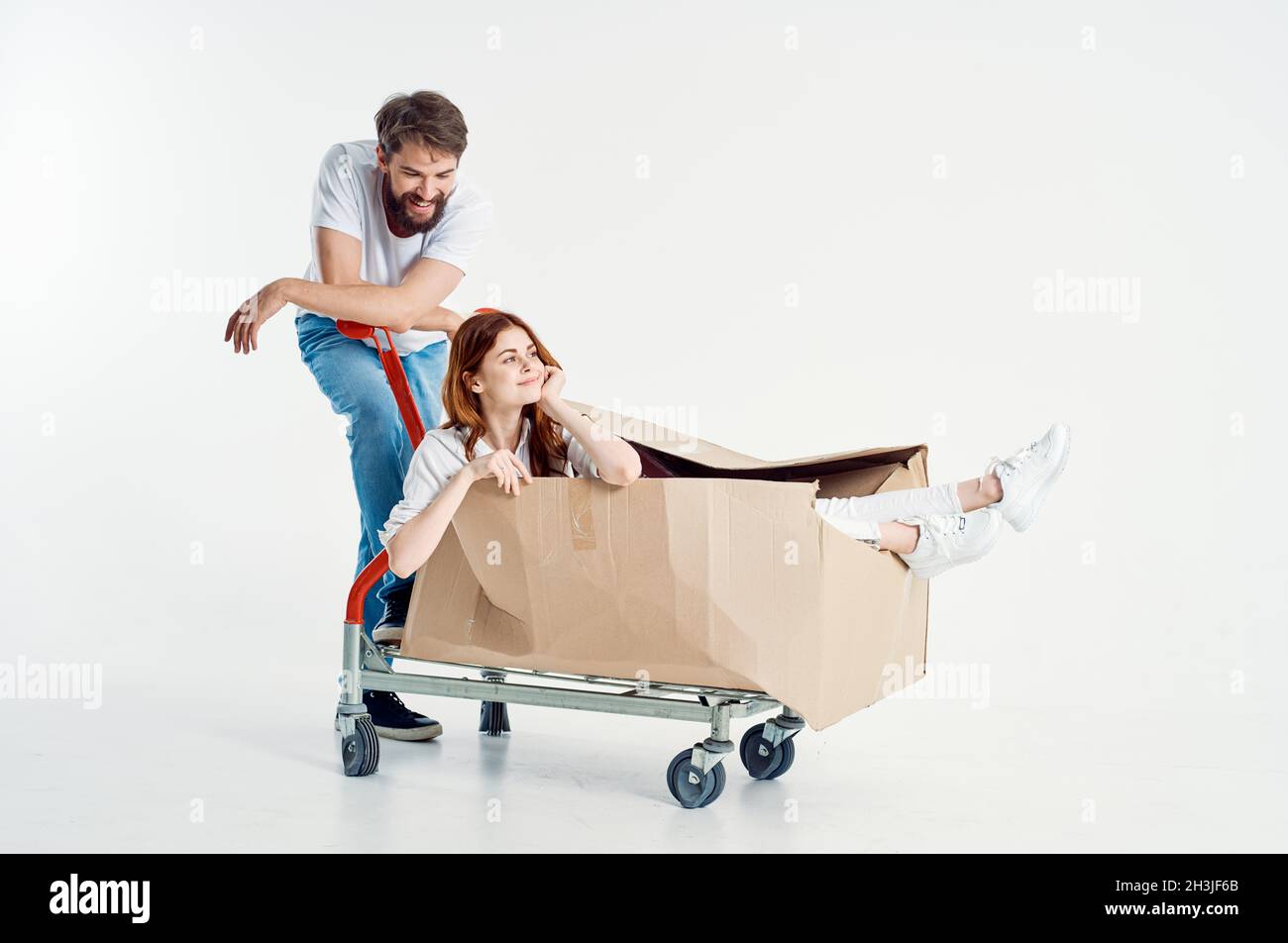 Man and woman ride a cart entertainment light background Stock Photo ...