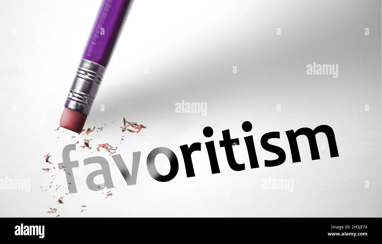 Eraser deleting the word favoritism Stock Photo - Alamy