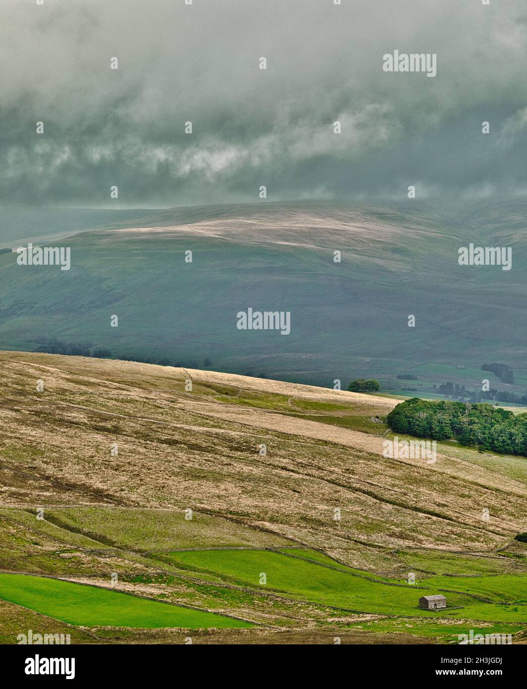 Panorama of mountains rugged terrain with stone barn and moorland ...