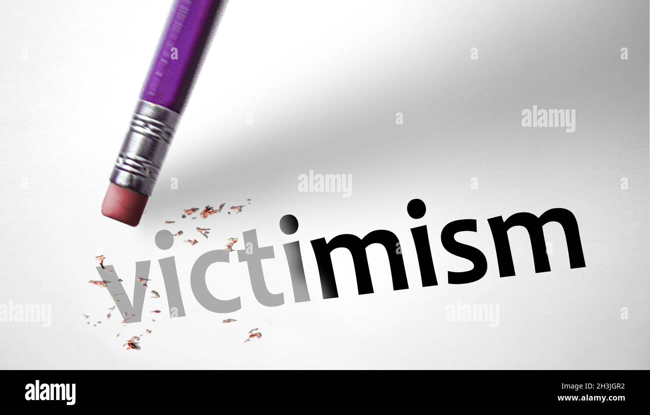 Eraser deleting the word Victimism Stock Photo - Alamy
