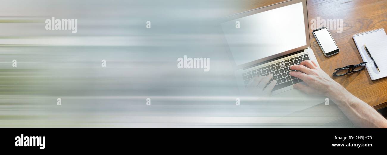 Hands of male professional typing on laptop keyboard with blank screen ...