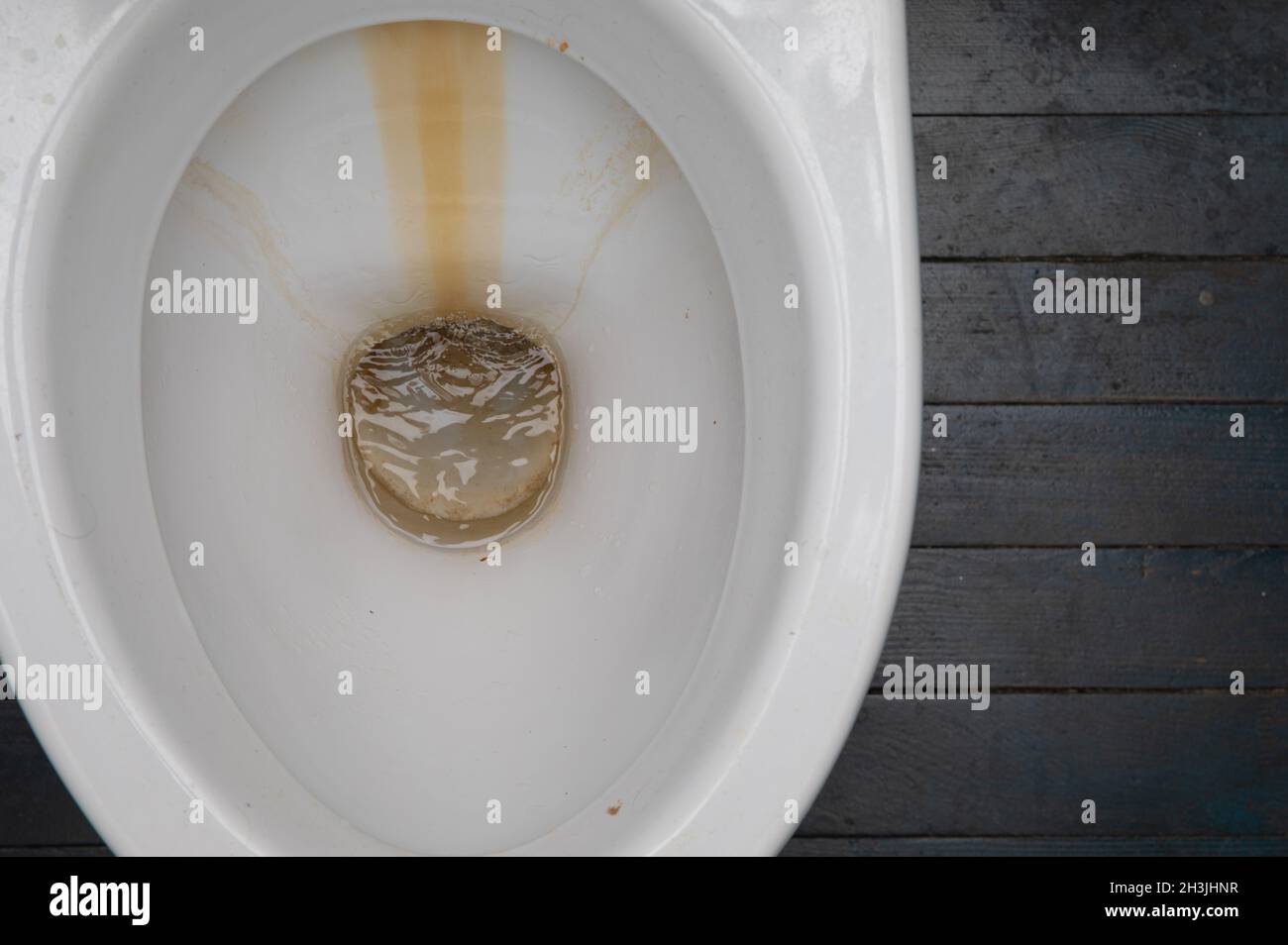 neglected toilet, traces of limescale, stone and rust Stock Photo - Alamy