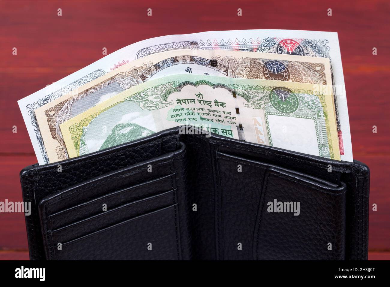 Nepalese money - rupee in the black wallet Stock Photo - Alamy