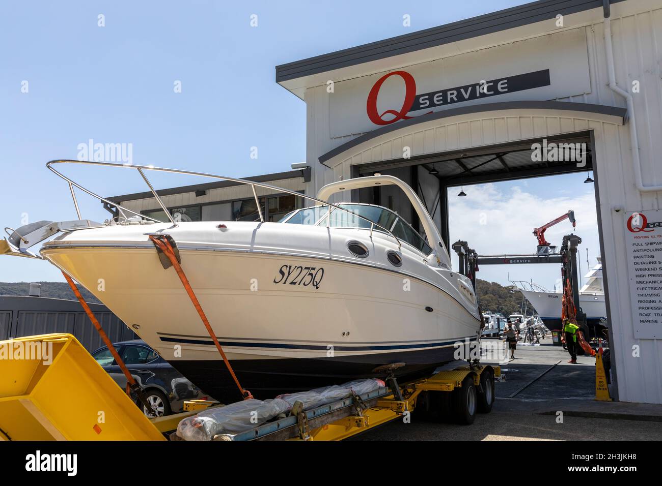 Sea Ray boat at a marina on Pi9ttwater in Sydney being prepared to lift ...