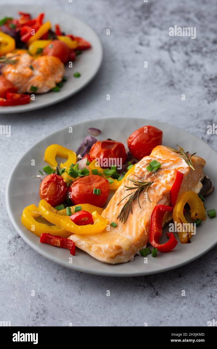 Baked red fish fillet Arctic char on a plates with vegetables close up ...