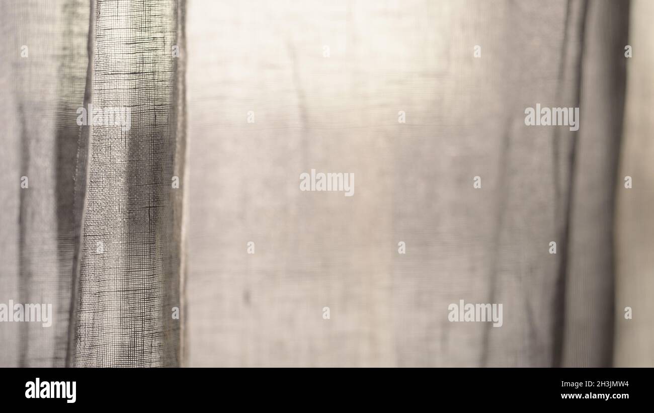 linen sheers sways on wind with sun shining through, wide photo Stock ...