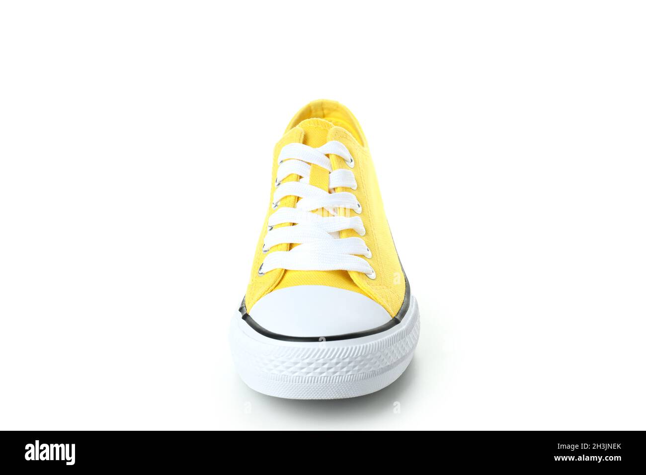 One yellow sneaker isolated on white background Stock Photo - Alamy