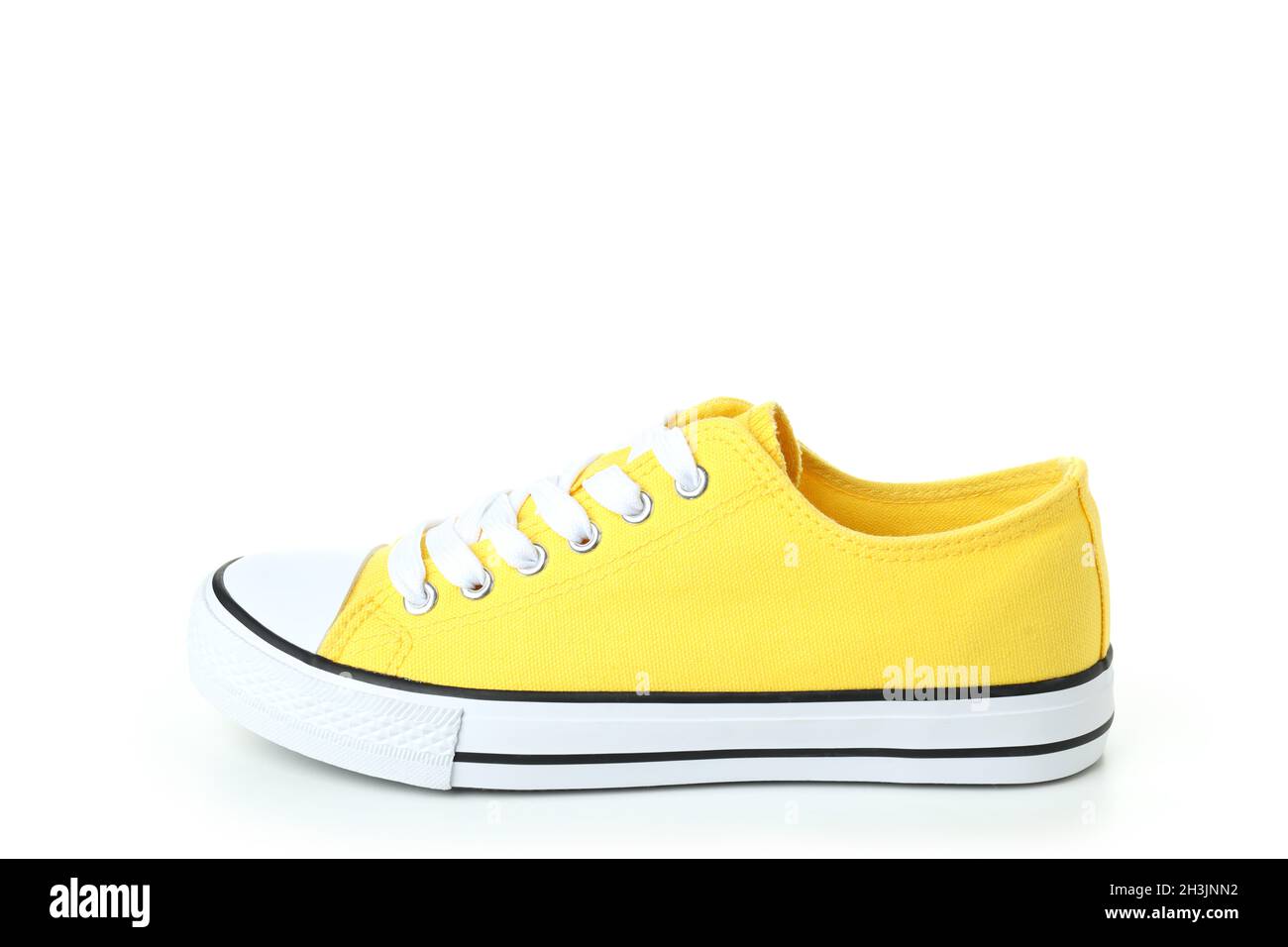 One yellow sneaker isolated on white background Stock Photo - Alamy