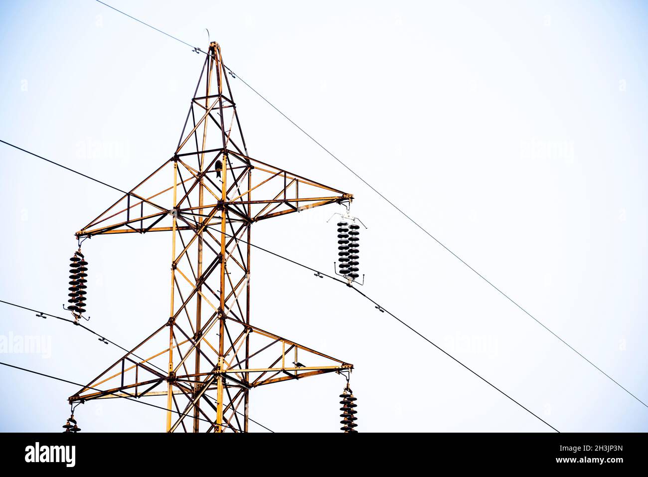 High-voltage electric power line isolated against blue sky Stock Photo ...