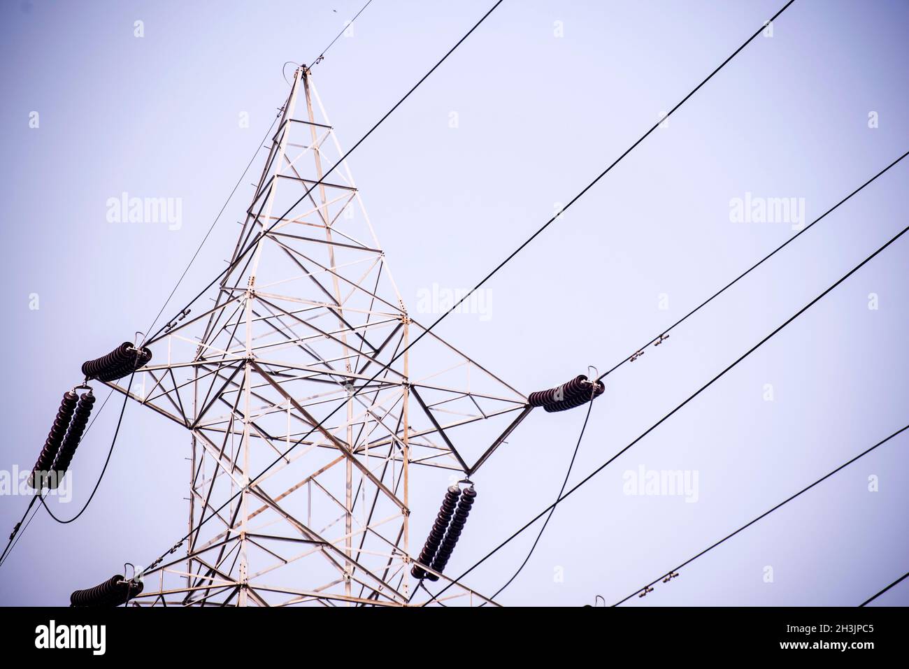 High-voltage electric power line isolated against blue sky Stock Photo ...