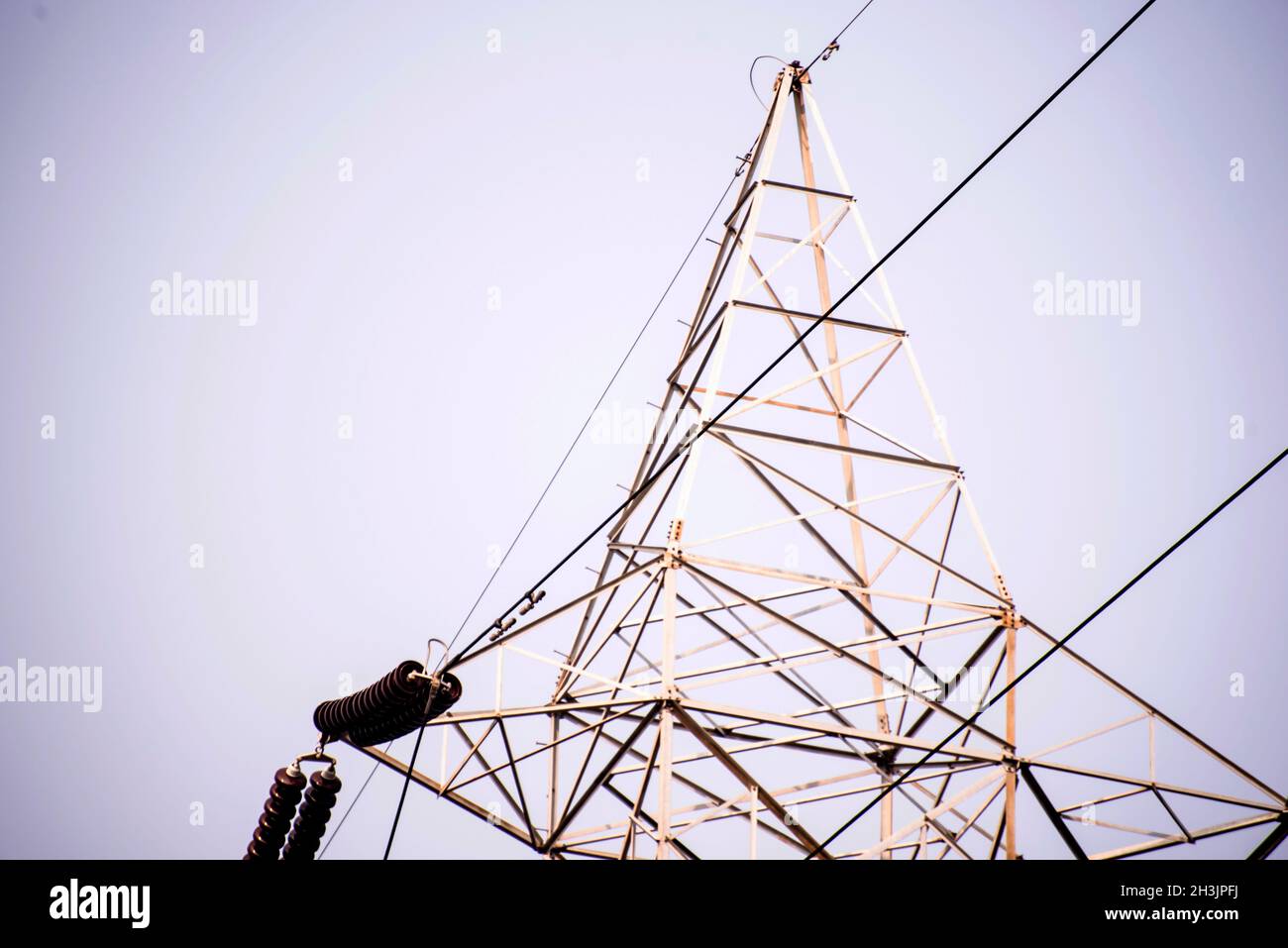 High-voltage electric power line isolated against blue sky Stock Photo ...