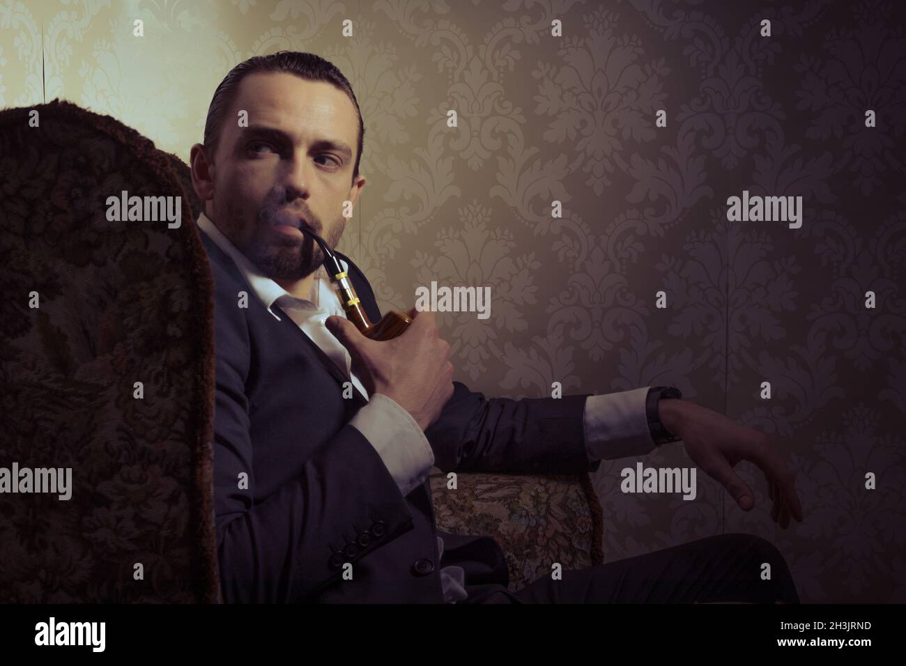 Man sitting in chair smoking hi-res stock photography and images - Alamy