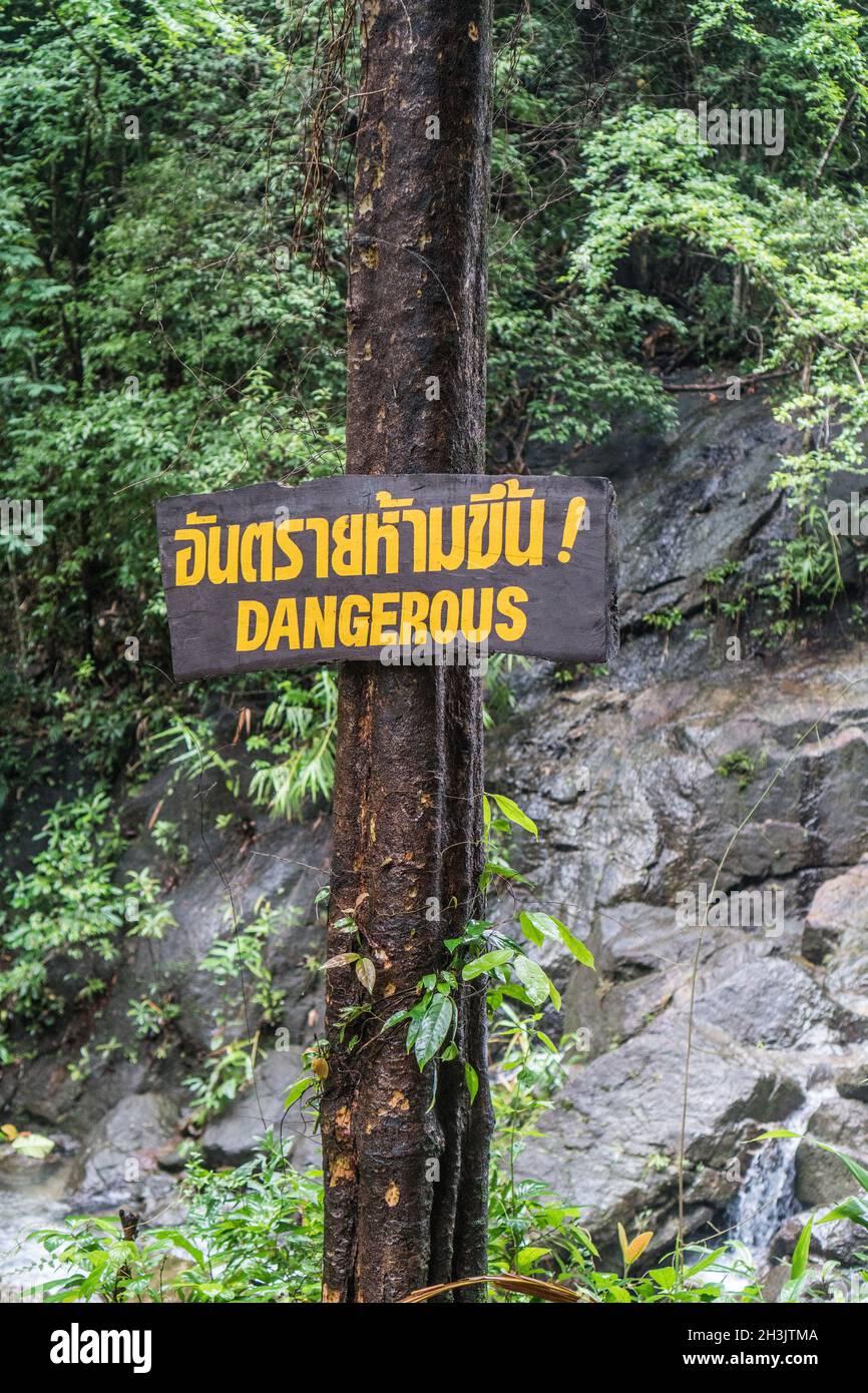 Dangerous sign over waterfall background Stock Photo - Alamy