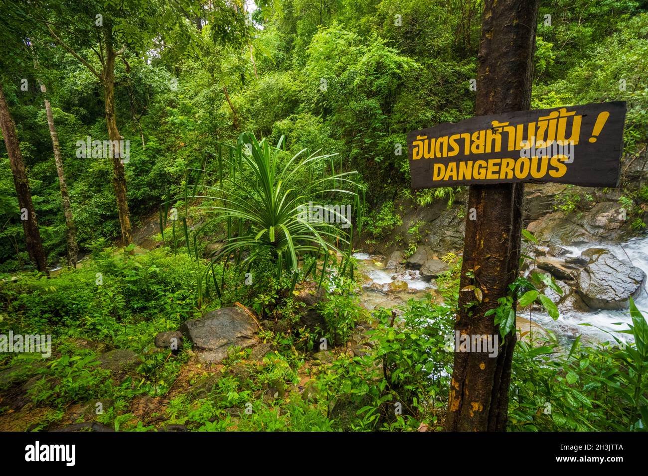 Dangerous sign over waterfall background Stock Photo - Alamy