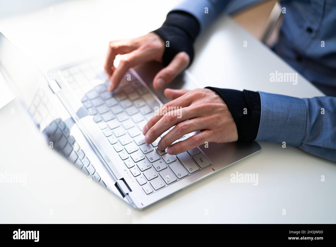 Pain Relief Bandage And Wrist Strap. Typing On Keyboard Stock Photo - Alamy
